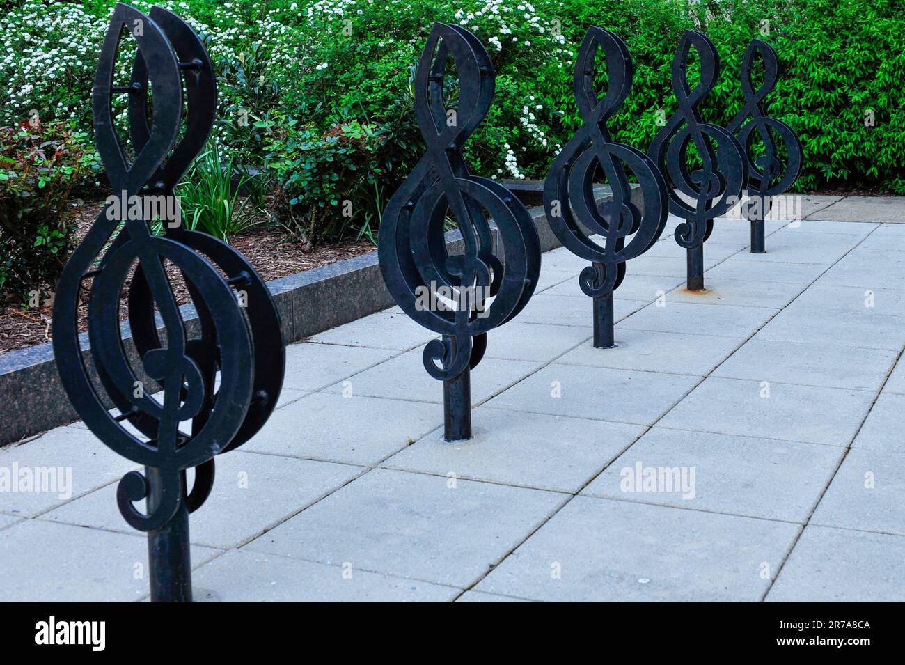 A close-up of an outdoor scene featuring a row of metal music notes on ...