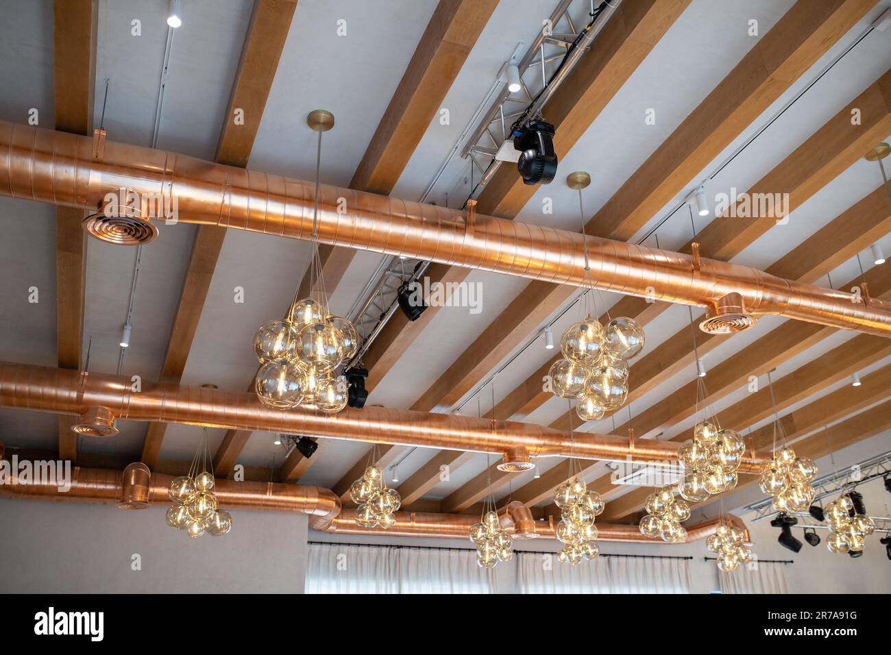Ceiling in a modern loft style with wooden beams, ventilation, trusses ...