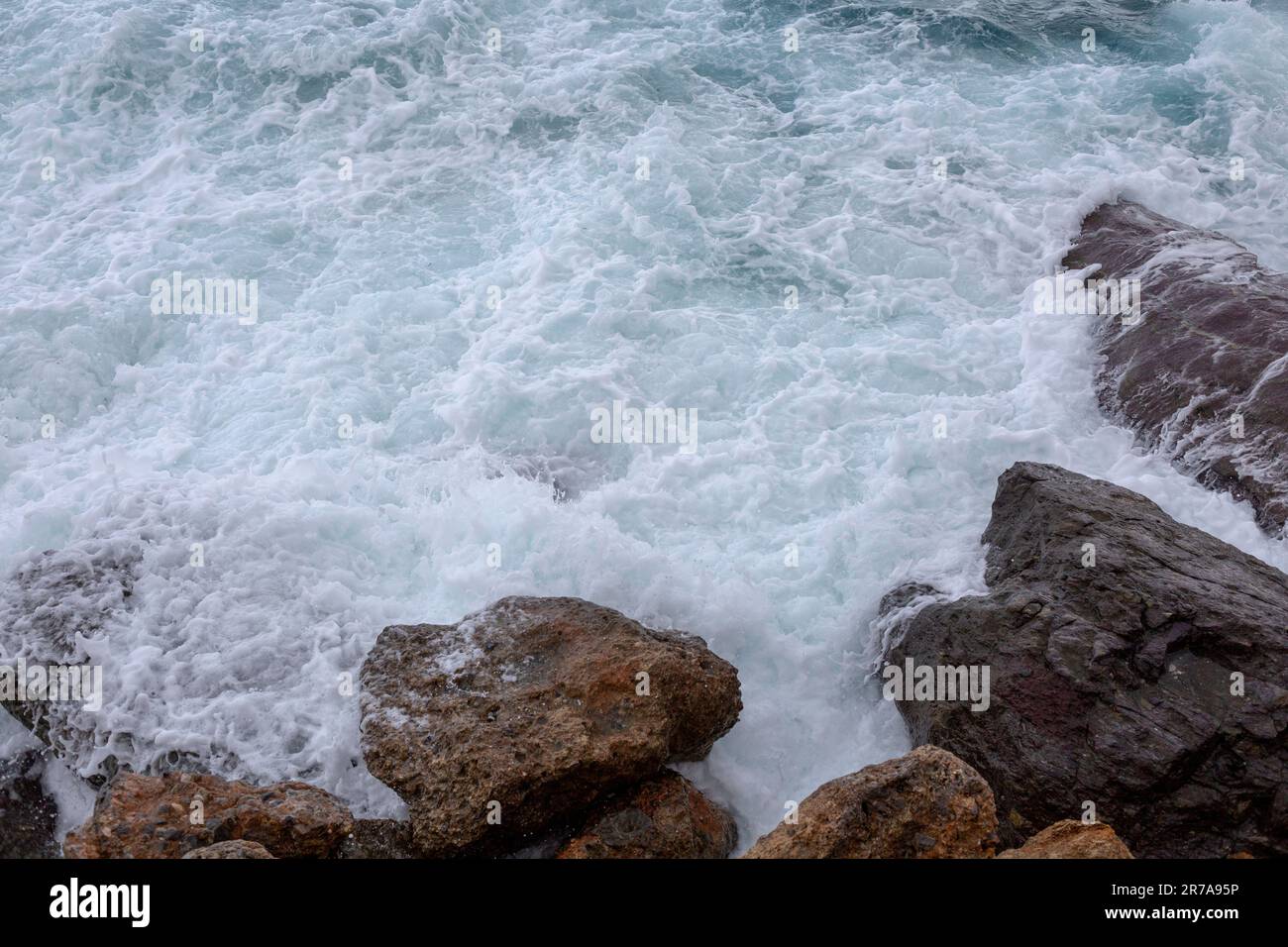 large sea waves crashing against the rocks and forming white foam Stock ...