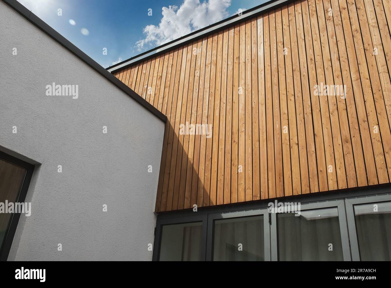 Exterior architectural detail of painted plaster and wood facade of ...