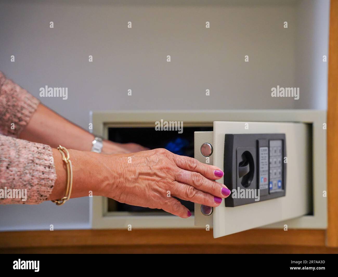 Unrecognizable woman opening the safe in a hotel Stock Photo - Alamy