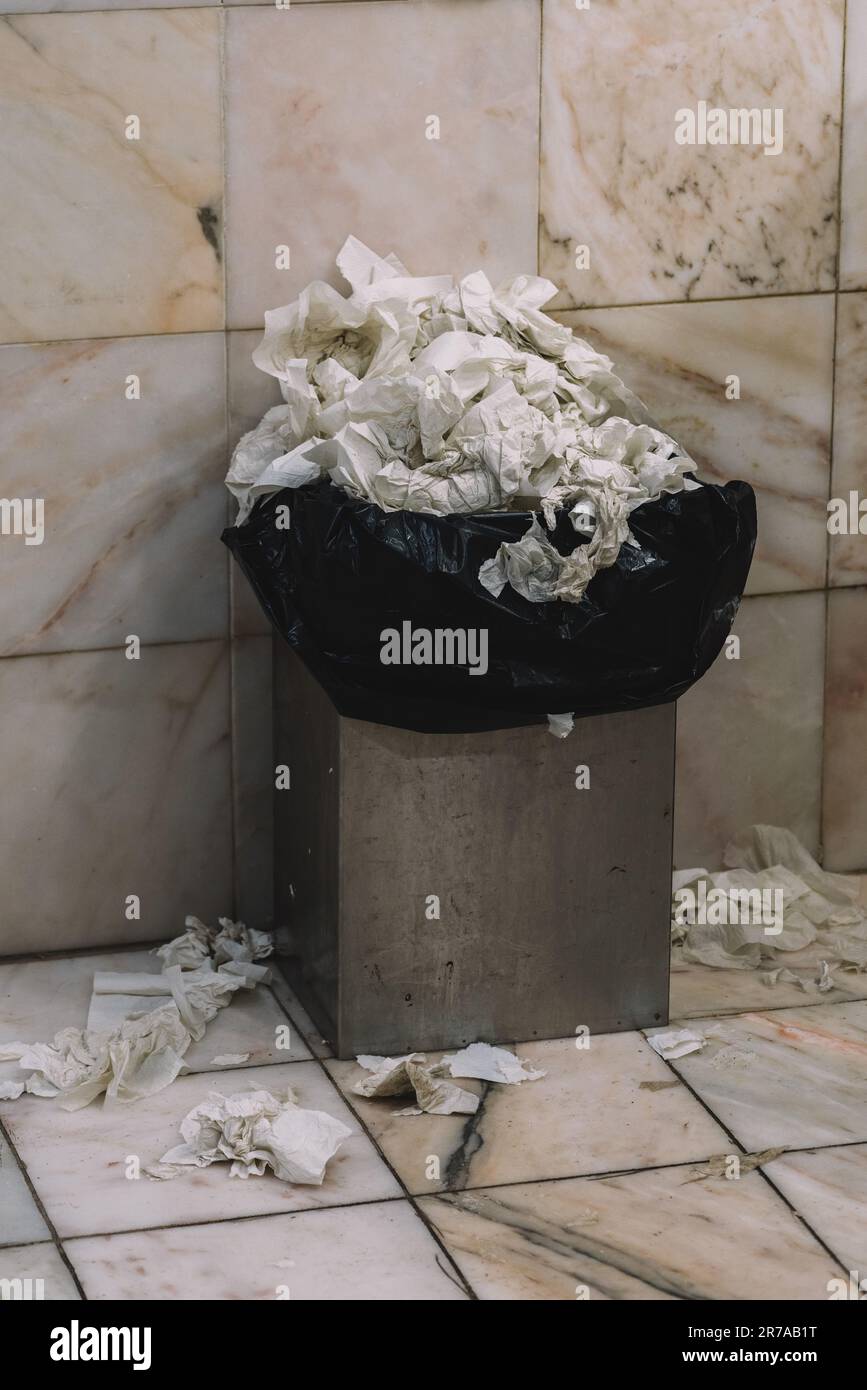 Bucket full of paper towels in a WC Stock Photo - Alamy