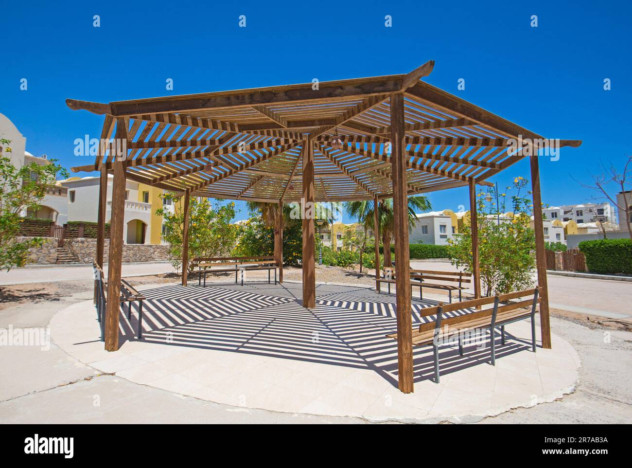 Large wooden pagoda frame structure outside in public park area with ...
