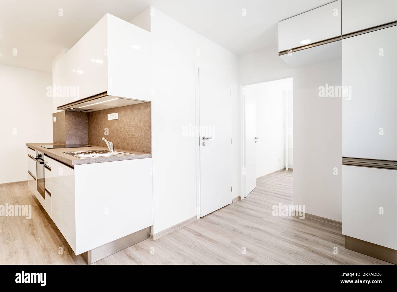 white kitchen unit in a new empty modern apartment Stock Photo - Alamy