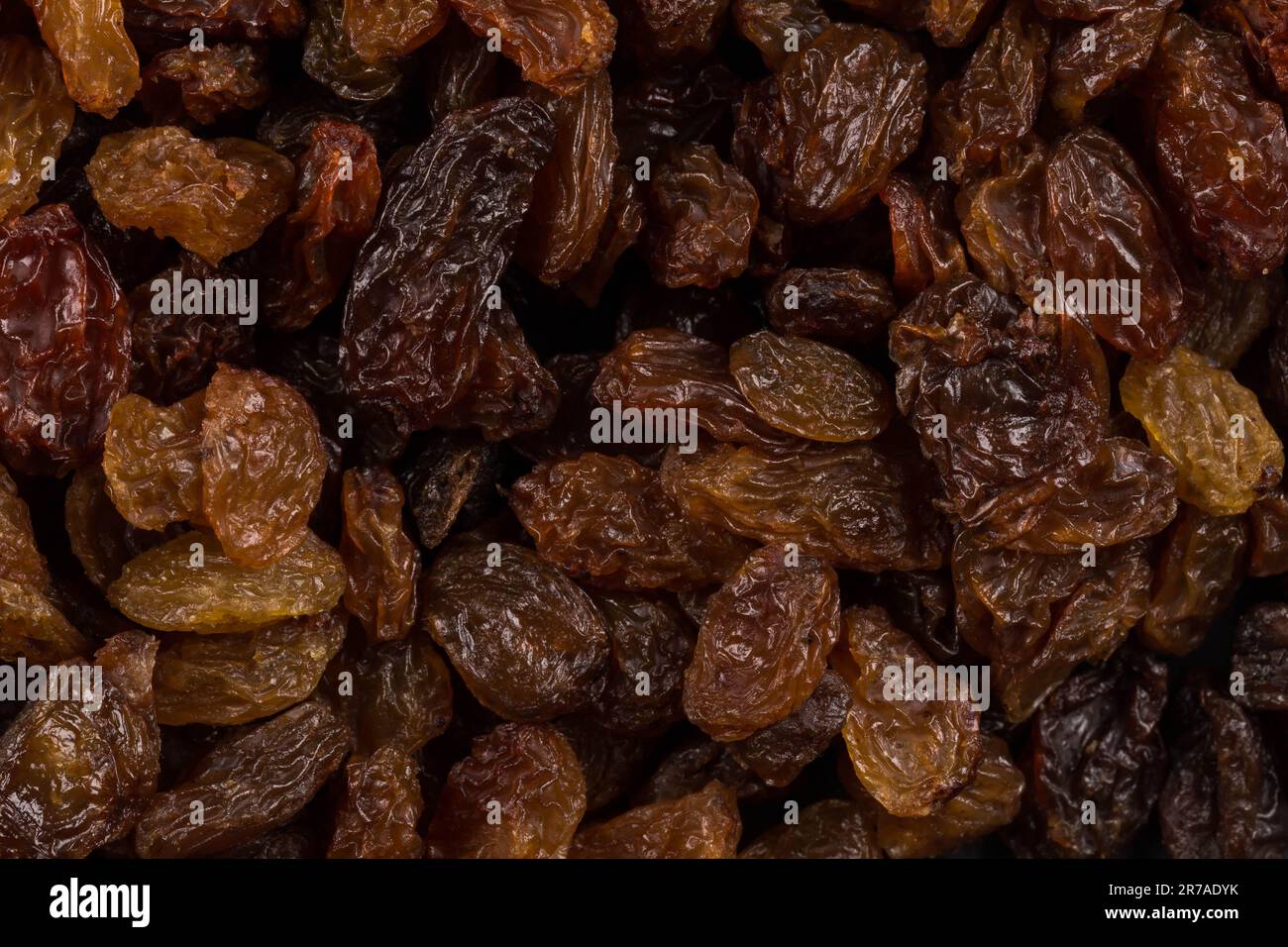 Sweet dry raisins close up shot for background Stock Photo - Alamy