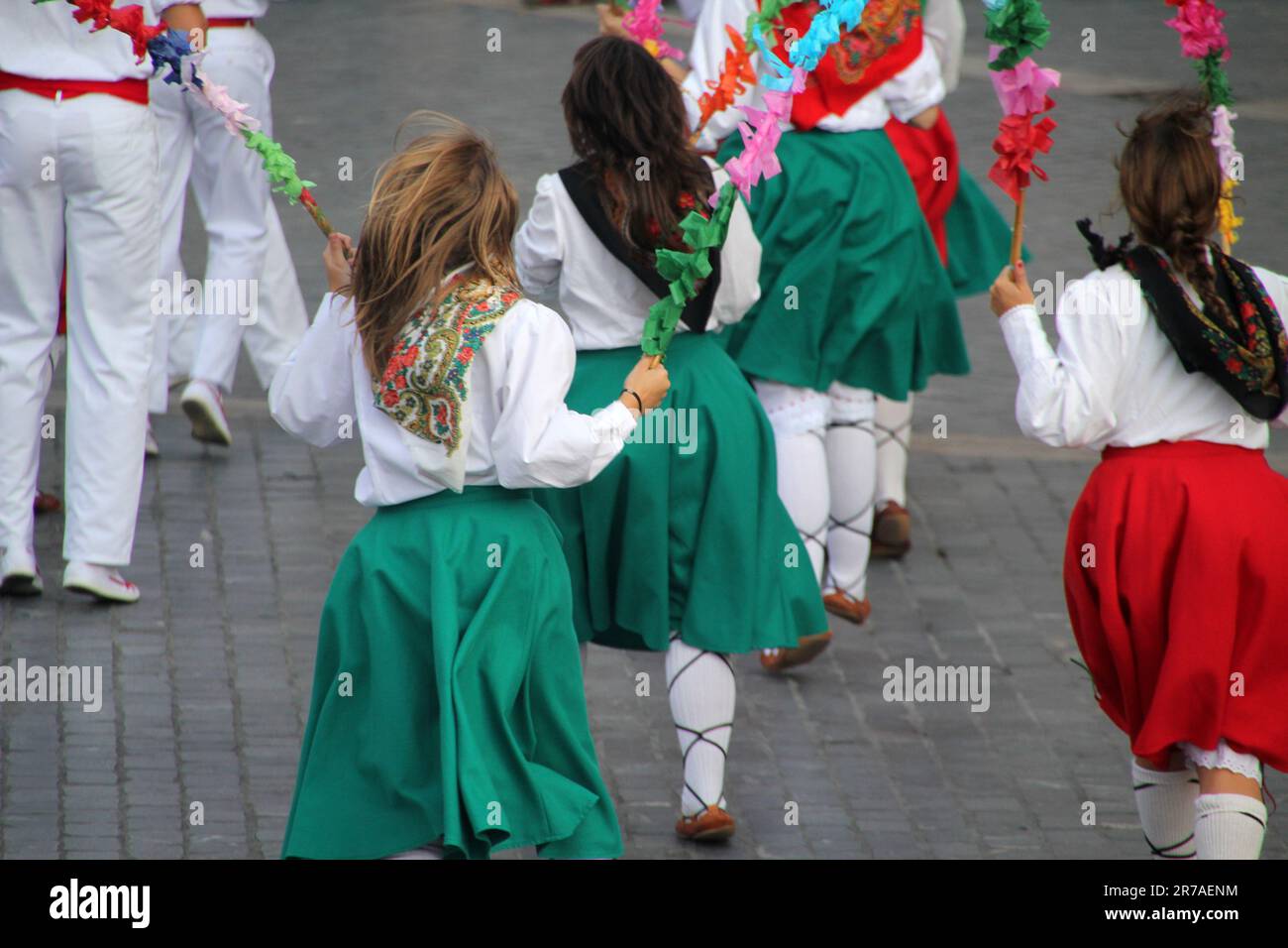 A diverse group of young women joyfully dancing in a circle in the ...