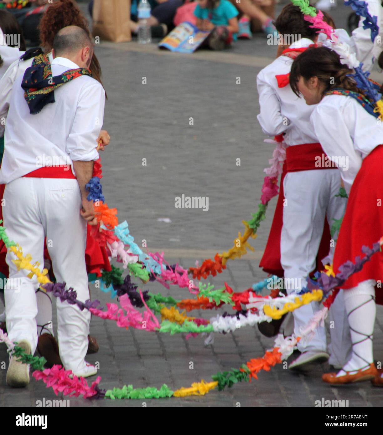 A diverse group of people wearing vibrant costumes and colorful flowers ...