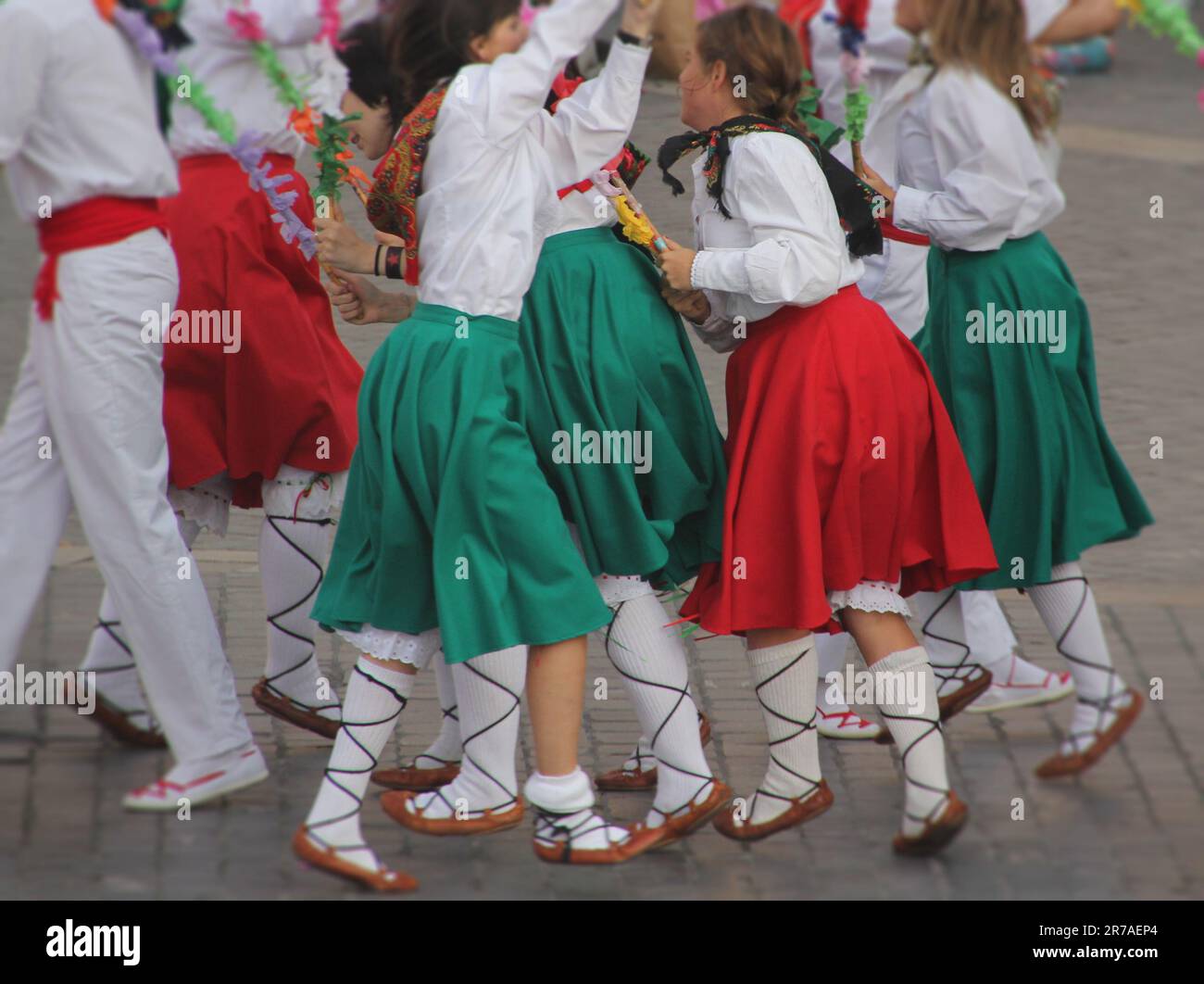 Two young girls wearing matching colorful dresses are dancing ...