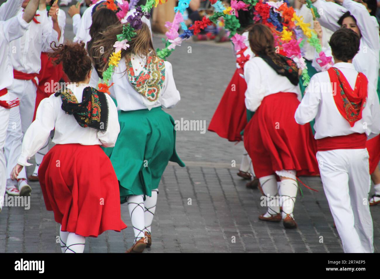 A diverse group of female models are marching in a parade down the ...