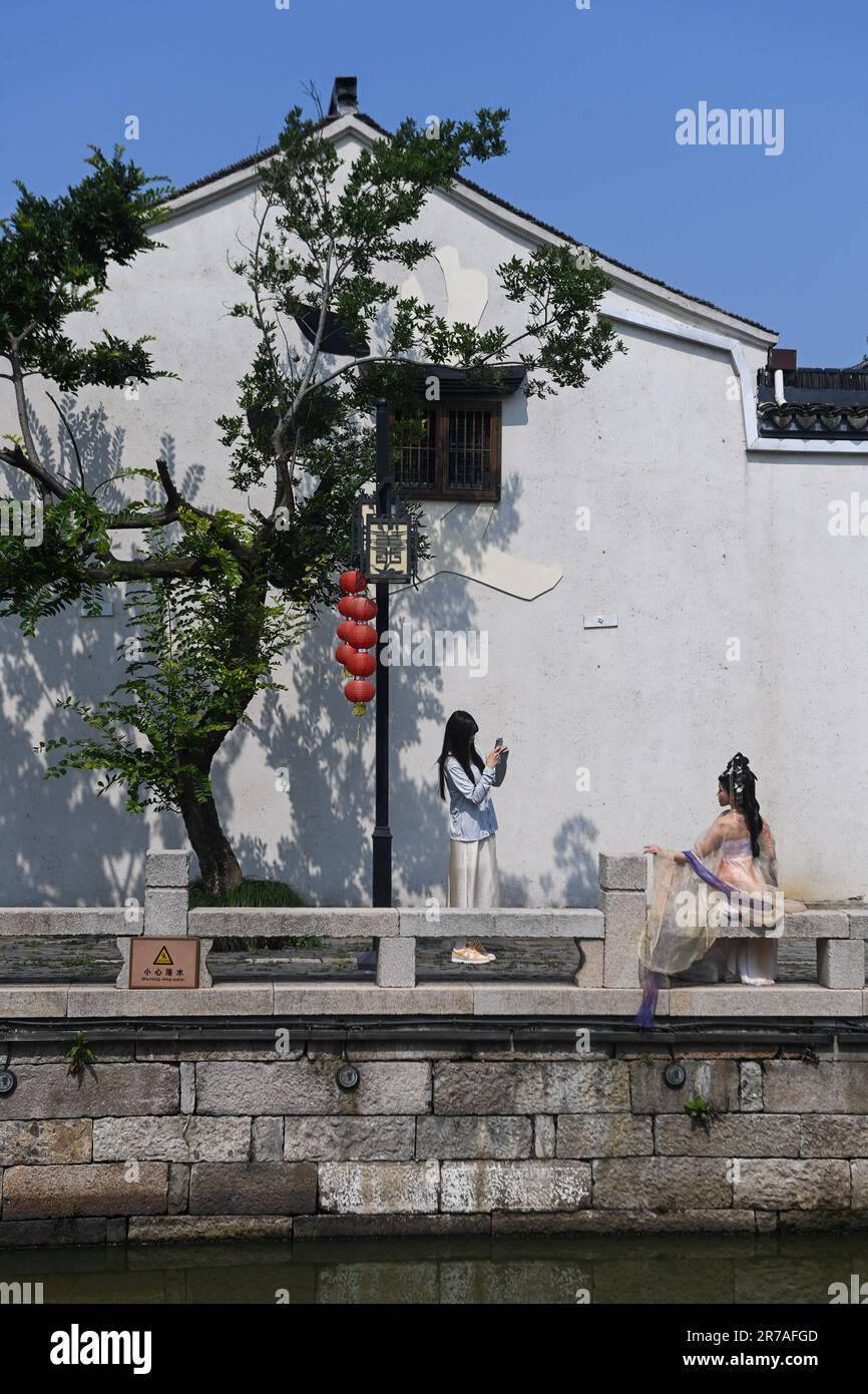 (230614) -- HUZHOU, June 14, 2023 (Xinhua) -- A tourist wearing ...