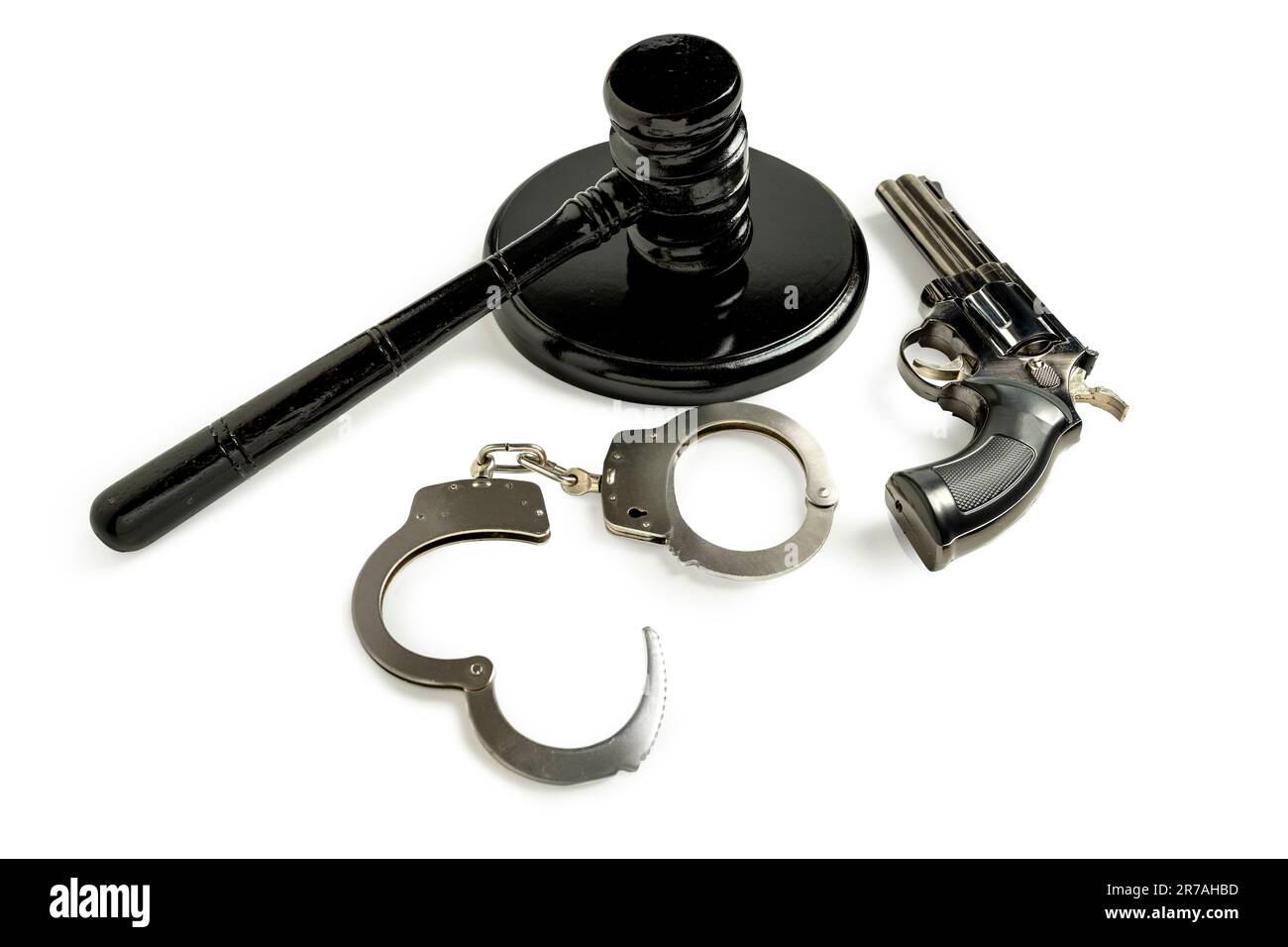 Judge gavel and soundboard with handcuff and gun on white background ...