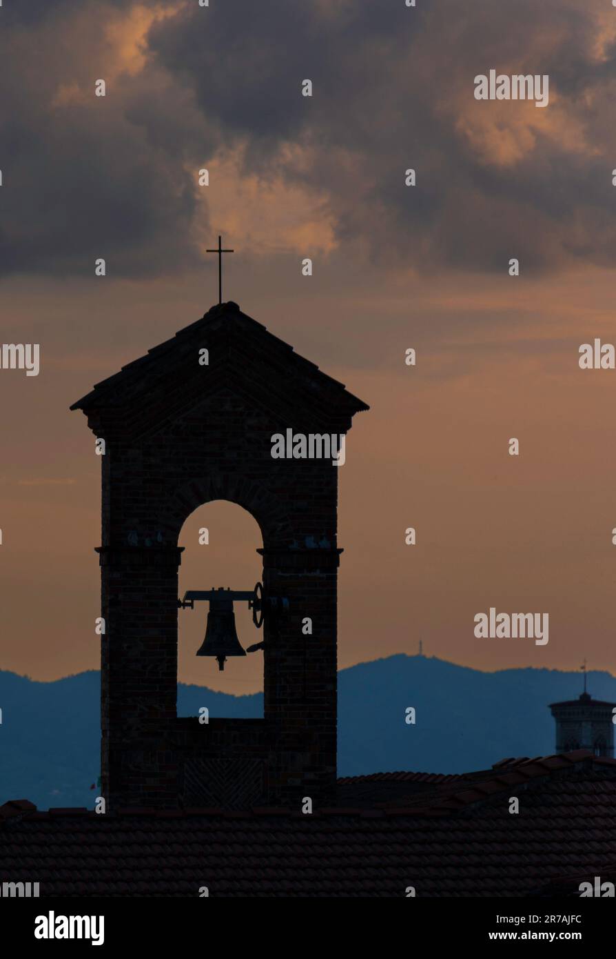 Bell on the bell tower against the background of the sunset sky, in ...