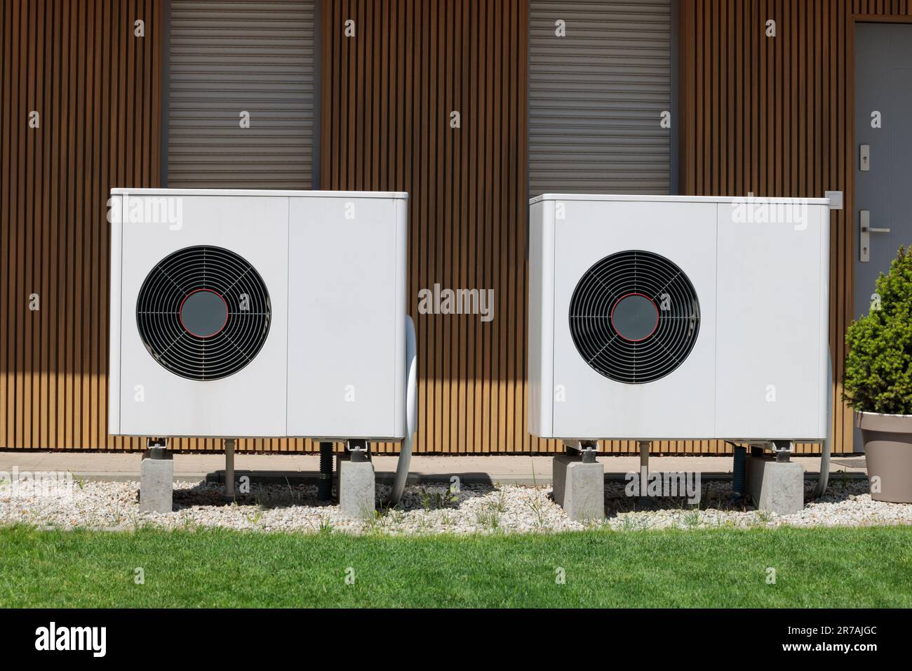 Air source heat pumps featured on modern house front. Renewable energy ...
