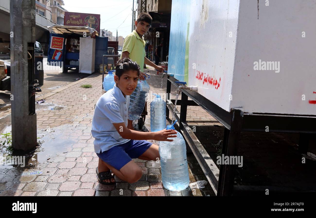 Beirut, Lebanon. 11th June, 2023. Children draw water in a street of Beirut, Lebanon, on June 11 ...