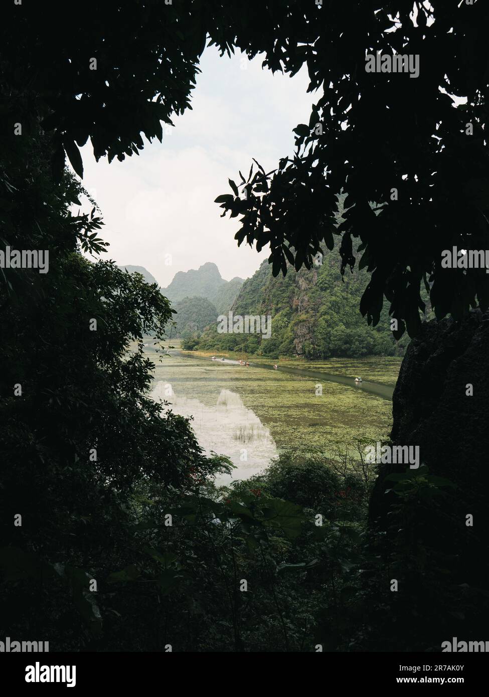 A scenic view of a river and mountains seen through a natural frame of ...