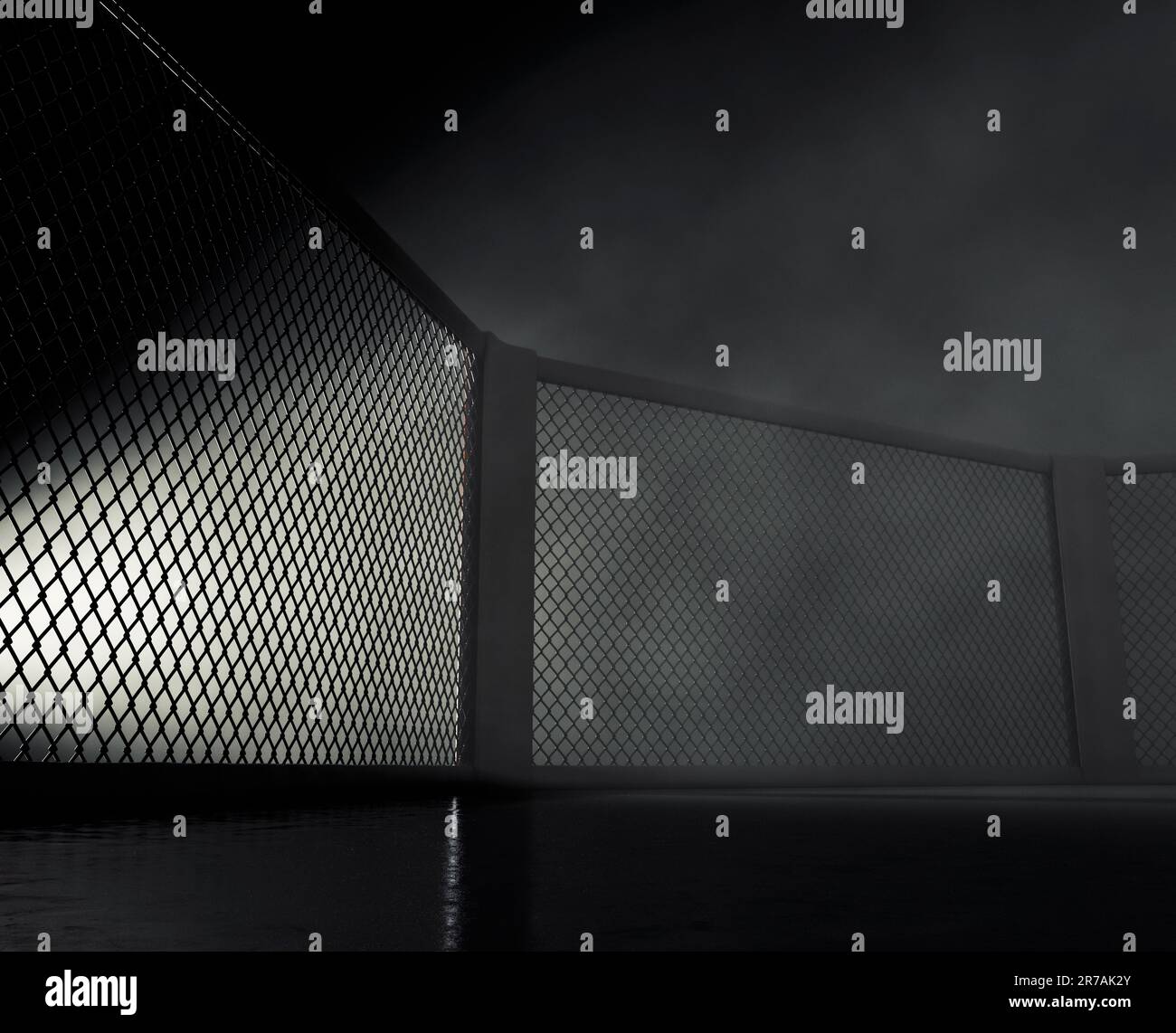 A dimly spotlit section of a mma octagon ring surrounded by wire mesh ...