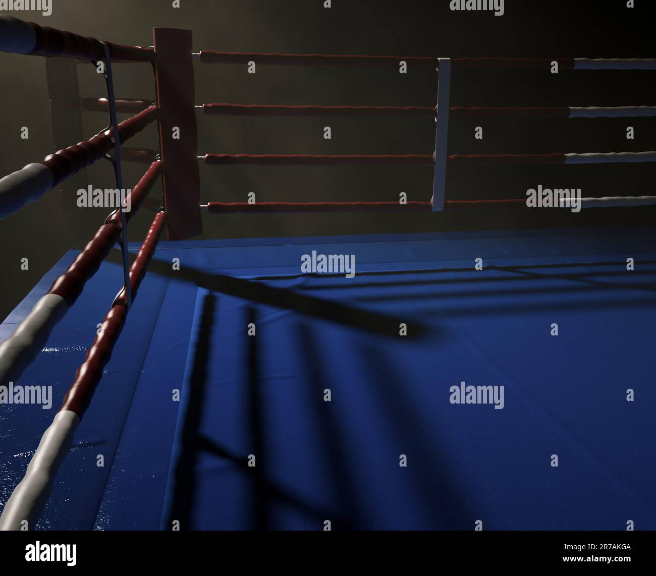 A dimly spotlit corner of a boxing ring surrounded by ropes on a dark ...