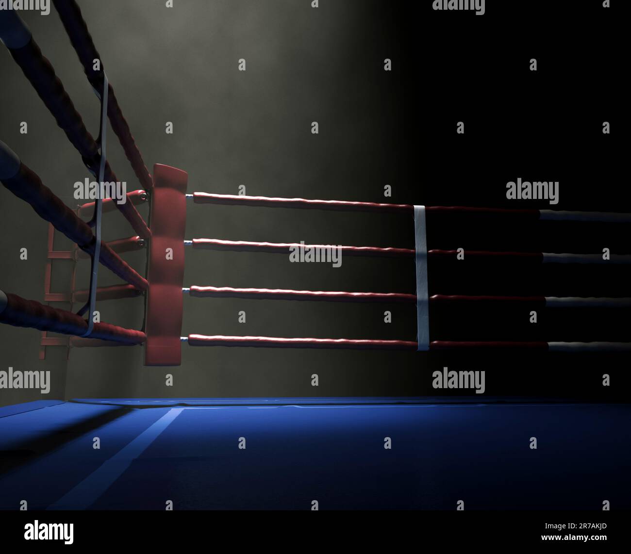 A dimly spotlit corner of a boxing ring surrounded by ropes on a dark ...