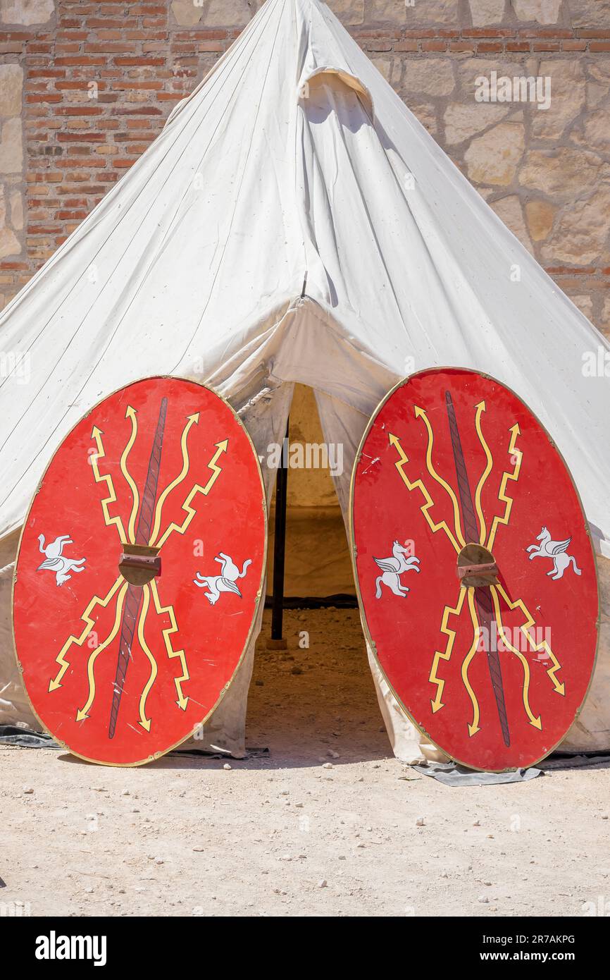 outdoor scene in vertical view of tent and oval shields of a soldier of ...