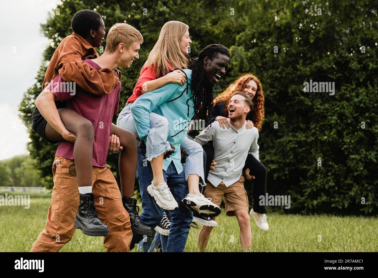 Multiracial group of people having fun outdoors - Young friends ...