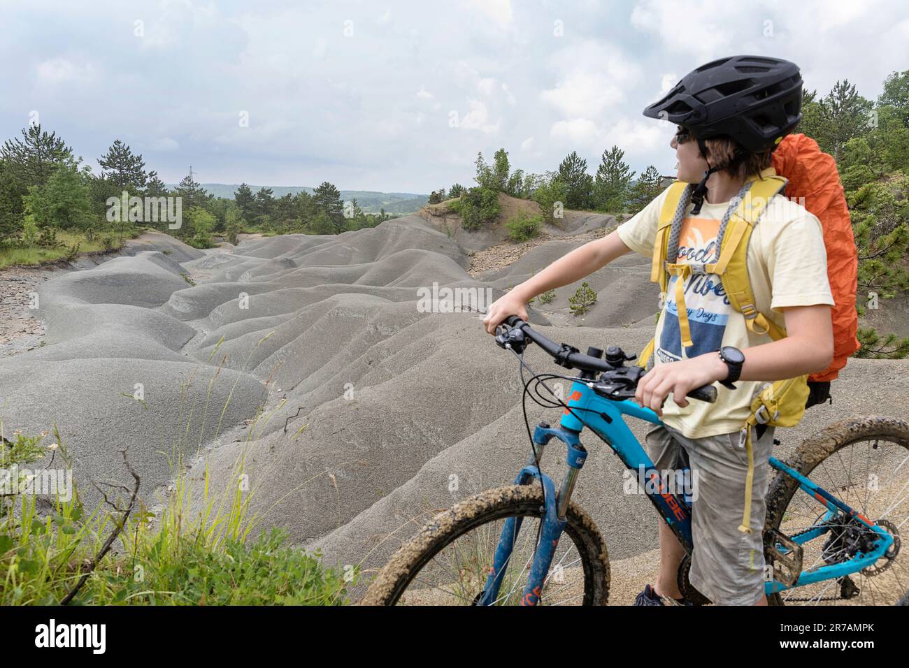 Tourist, a boy, cyclist on a mountain bike, exploring desert like ...