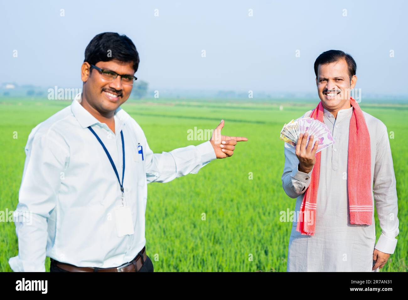 Happy indian banker showing by pointing finger to farmer with counting ...