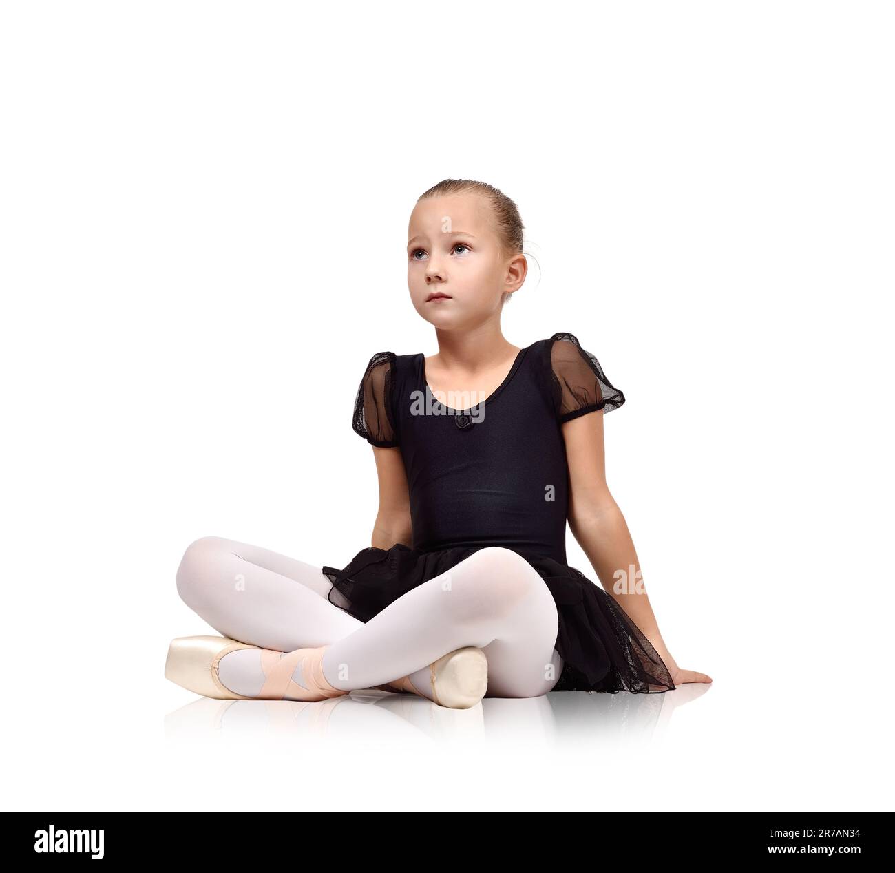 little ballerina kig sitting on floor in black tutu Stock Photo - Alamy