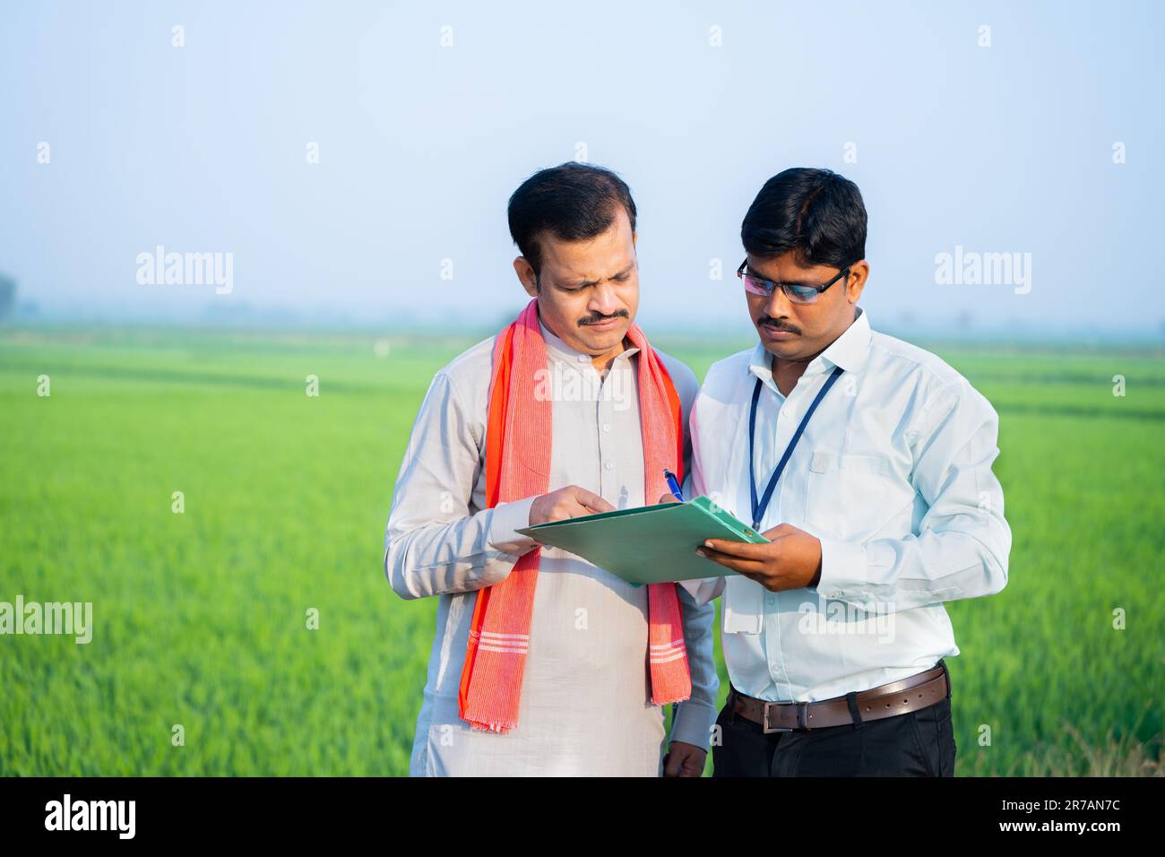 Indian officer writing by asking questions to village farmer at ...