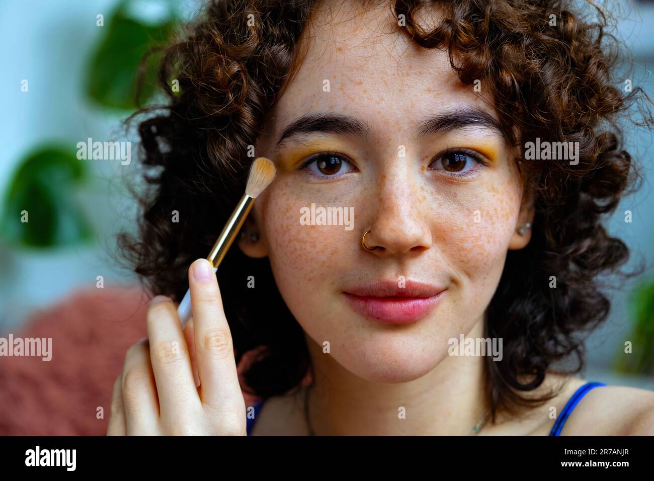 closeup woman applying makeup at home with brush Stock Photo - Alamy