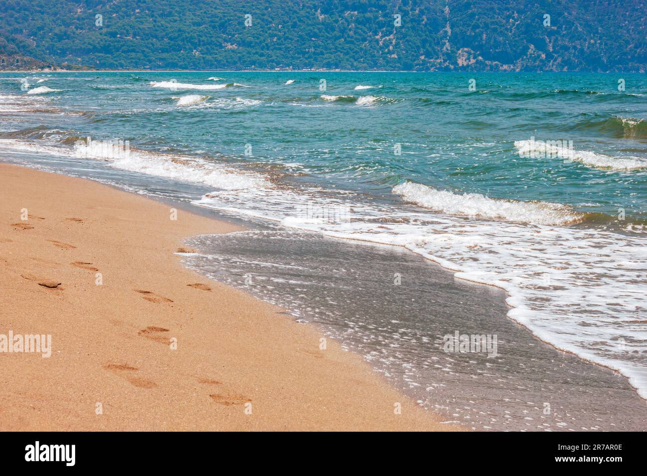 Blue and turquoise color sea waves with white foam and yellow sandy ...