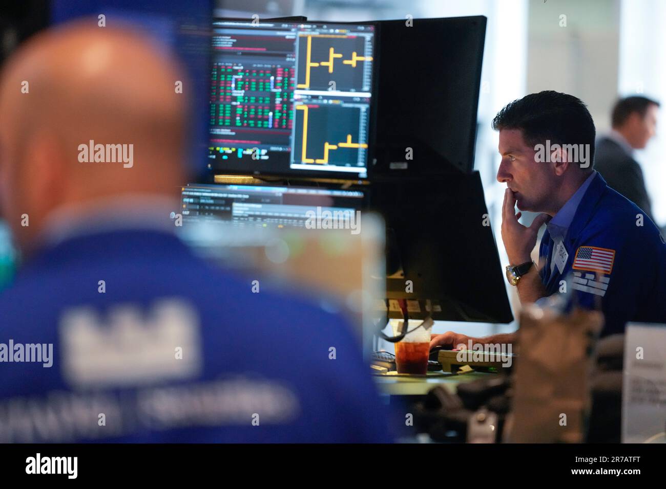 Traders work on the floor at the New York Stock Exchange in New York ...