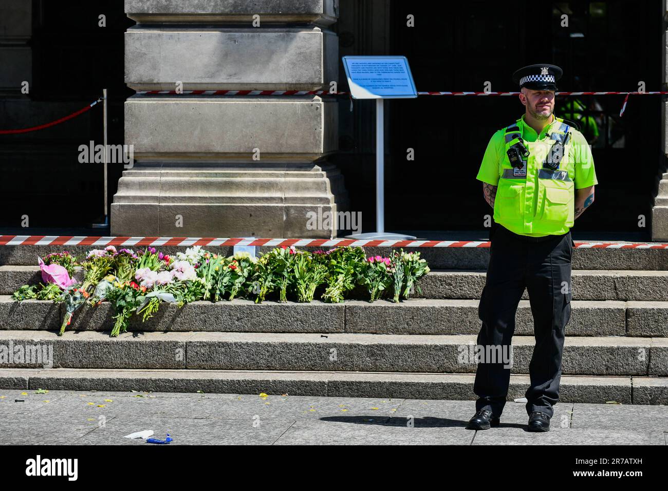 Nottingham attacks: A policeman stands watch over the floral tributes ...