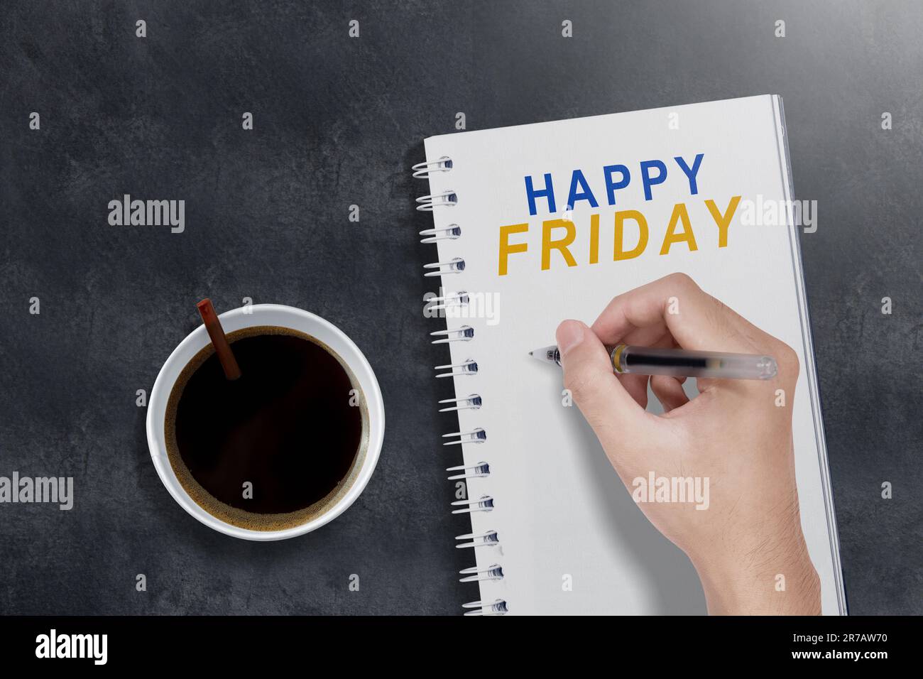 Coffee cup with human hand writing Happy Friday text on a notebook ...