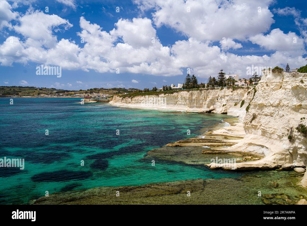 The Saint Thomas Bay under a blue cloudy sky in Malta Stock Photo - Alamy