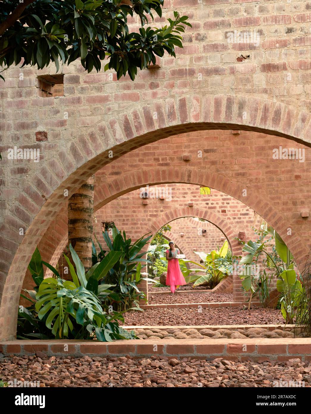 View though arches with housekeeper in colourful sari. Subteranian ...