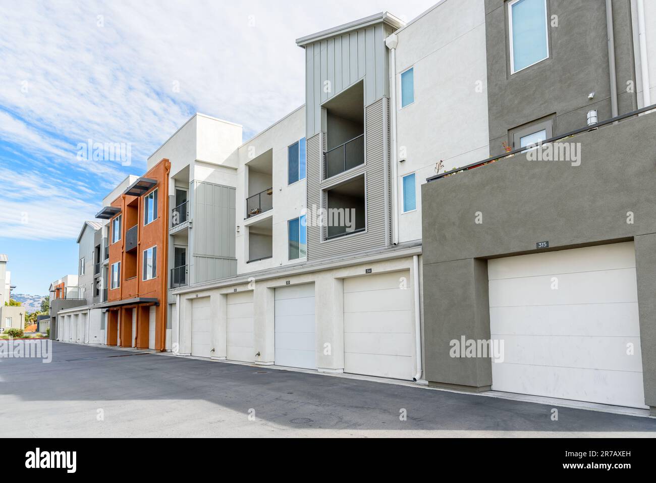 Row of garages at the back of a modern apartment building on a sunny ...