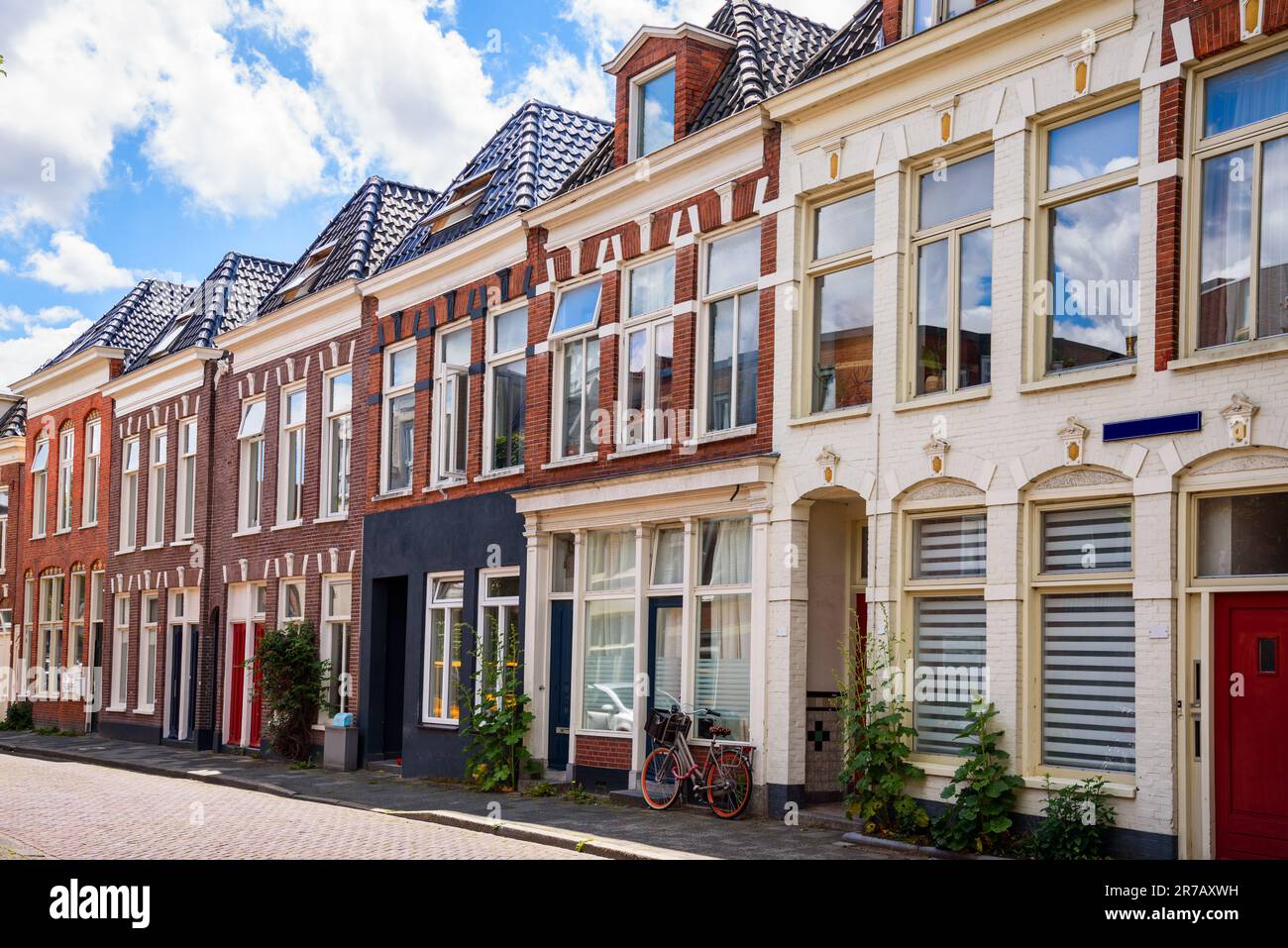 Traditional row houses along a cobbled street on a sunny summer day ...