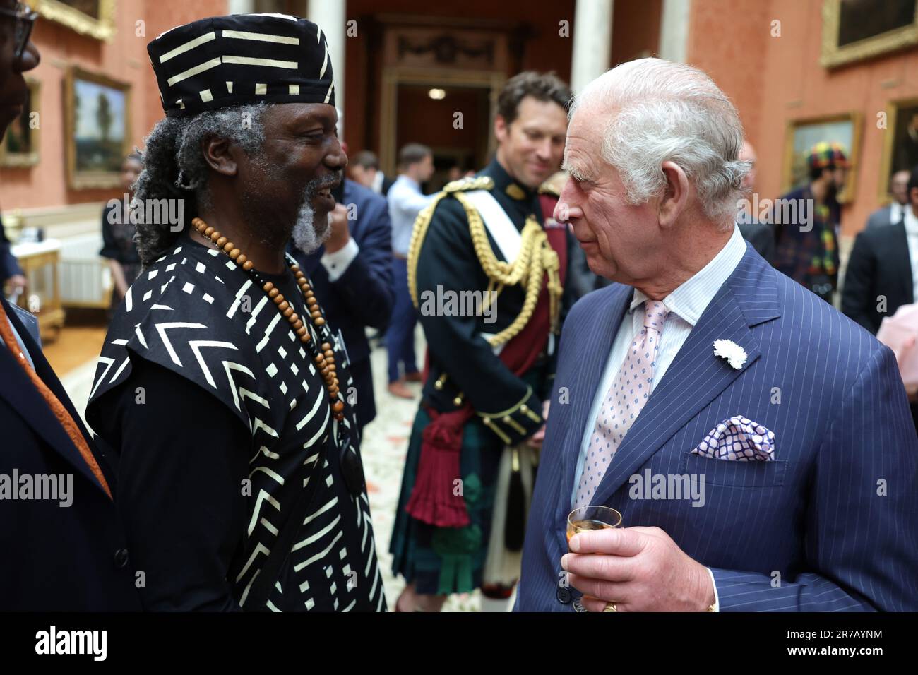 King Charles III speaks with a guest during a reception at Buckingham ...