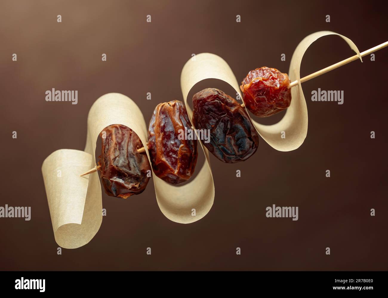 Dried Arabic dates on a brown background Stock Photo - Alamy