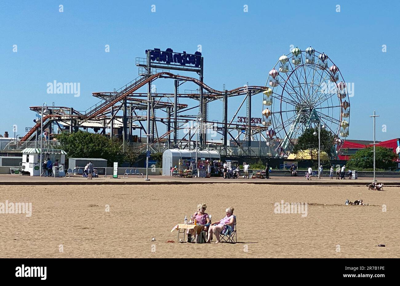 Skegness, UK. 14th June, 2023. Two women picnic on the beach in front ...