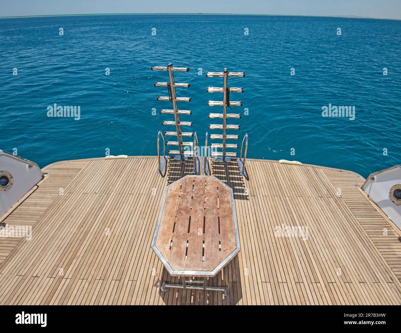 Metal steel ladders on back teak wooden deck of a large luxury motor ...