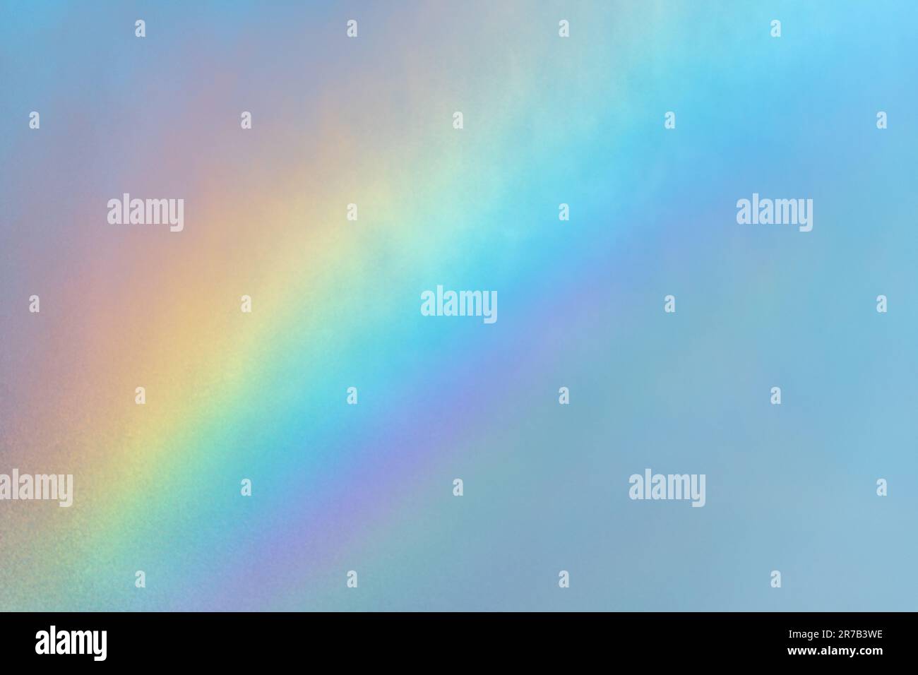 Rainbow colors in the stream of water from an agricultural sprinkler ...