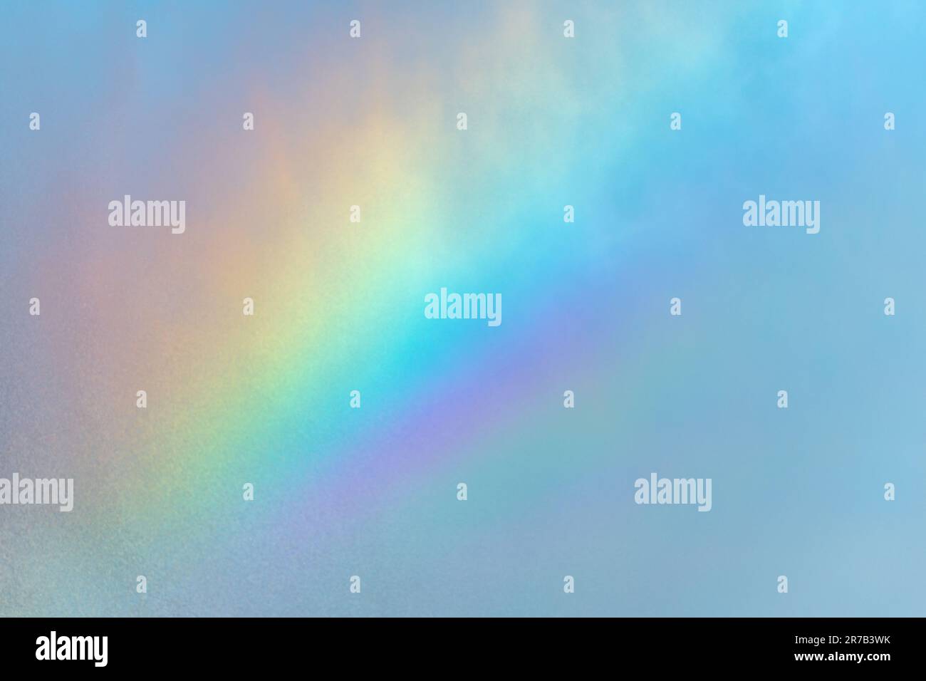 Rainbow colors in the stream of water from an agricultural sprinkler ...