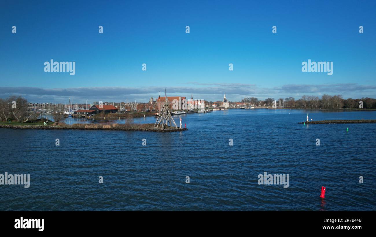 At the markermeer lake the wooden lighthouse and harbor entrance of the ...