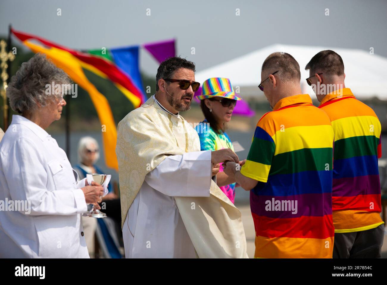 Rev. Dr. Jared Cramer of St. John's Episcopal Church hands out bread ...
