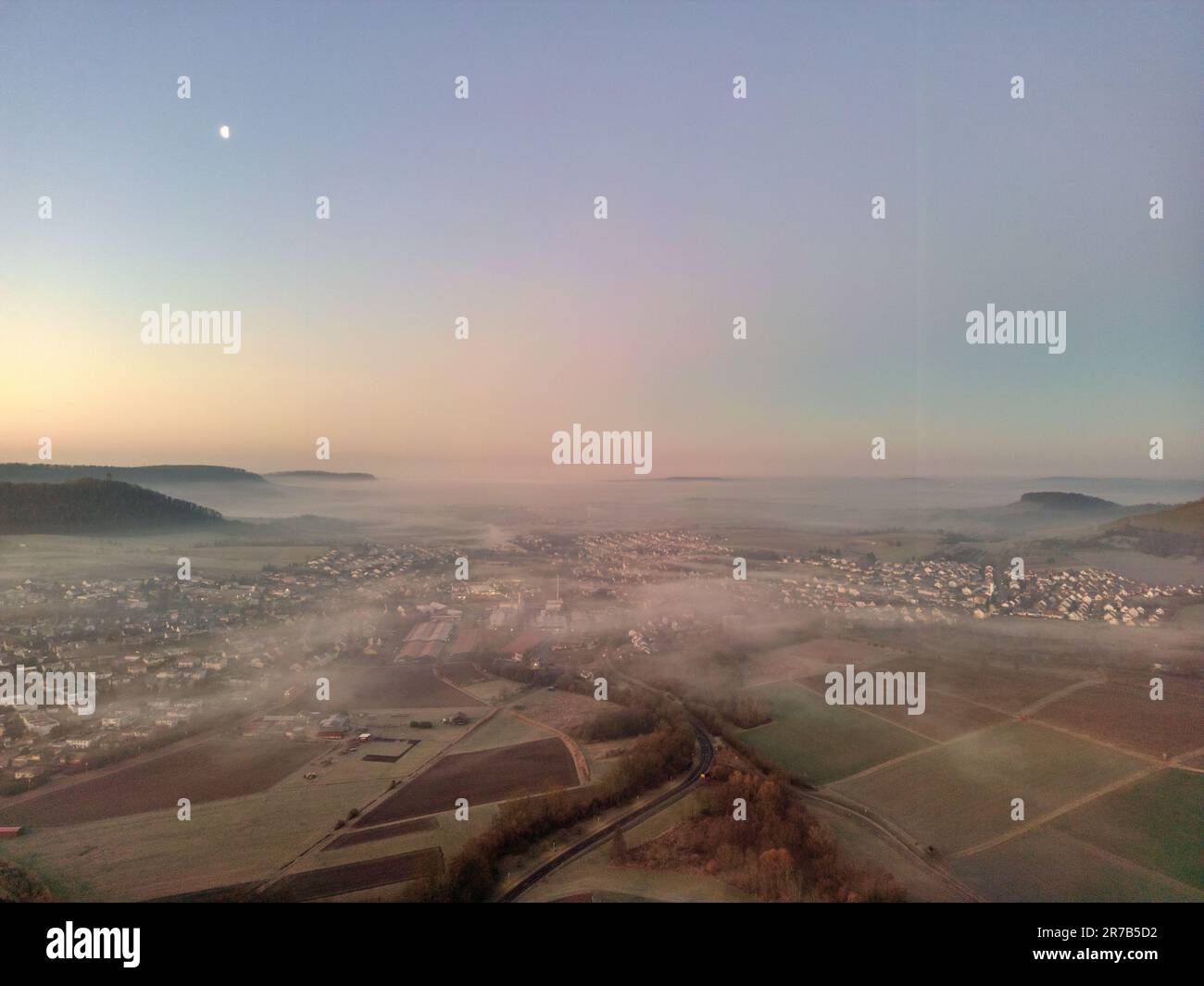 An aerial stunning view of a foggy sunset over Oberstenfeld, Germany ...