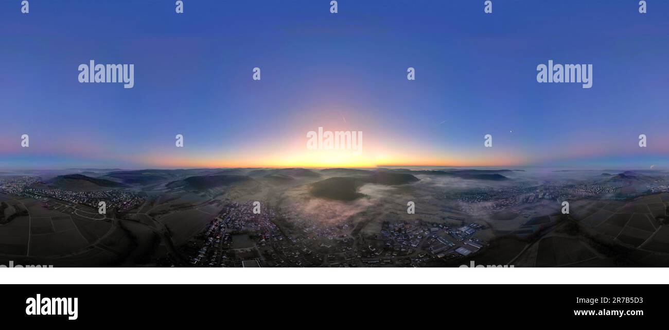 An aerial stunning view of a foggy sunset over Oberstenfeld, Germany ...