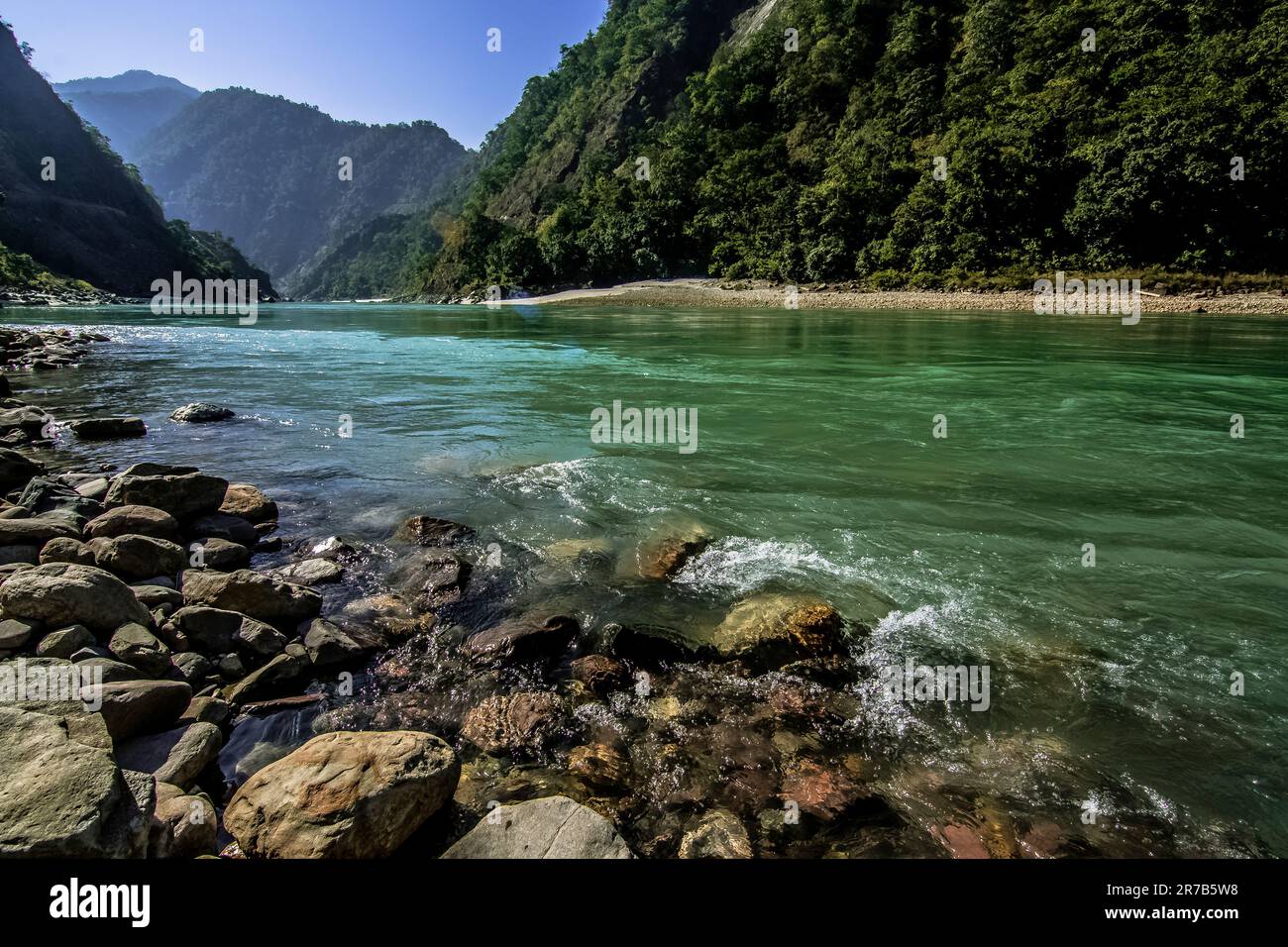 A scenic view of the Ganges surrounded by green mountains. Uttarakhand ...