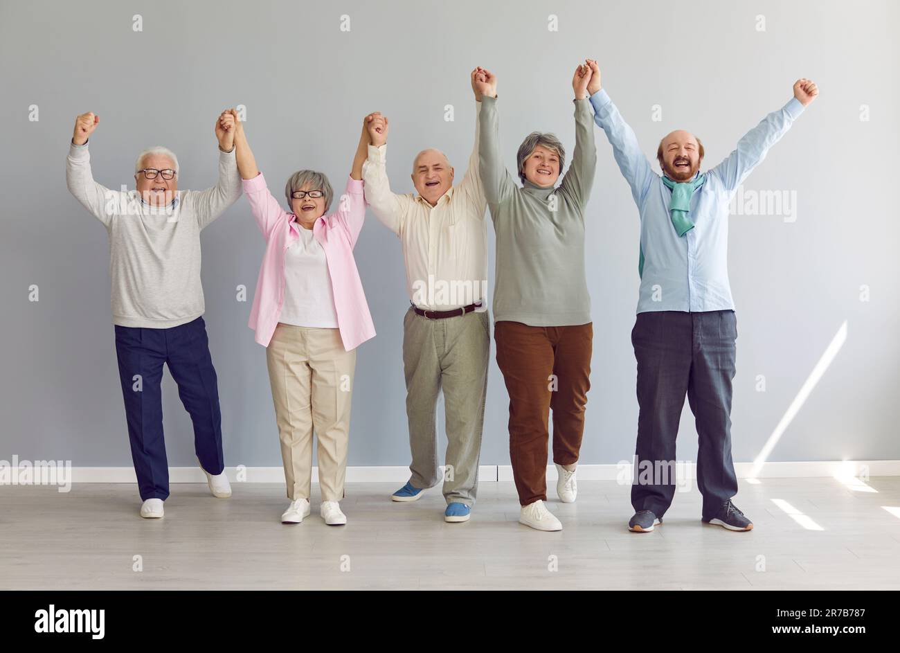 Group of joyful healthy senior retired men and women standing together ...