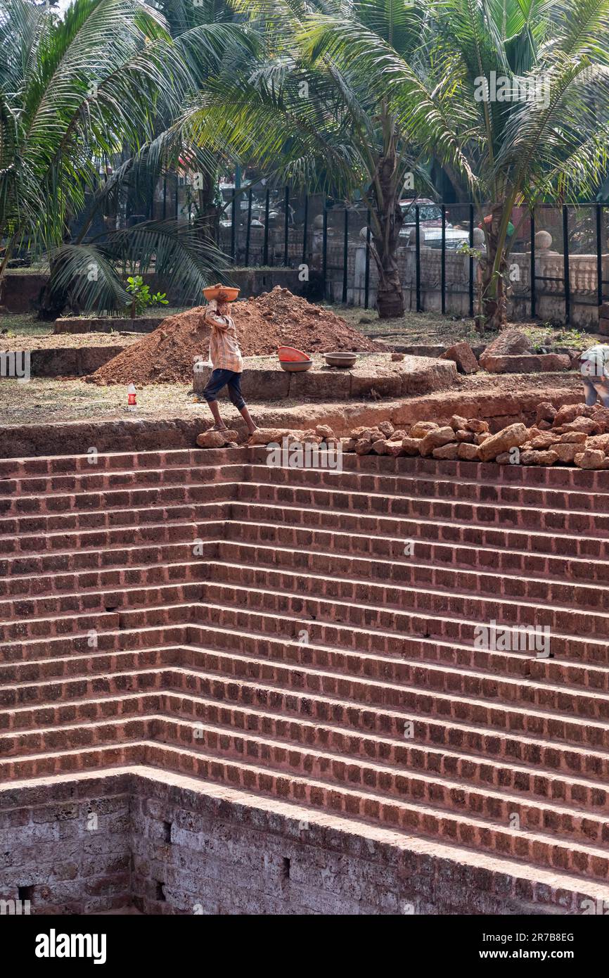 Old Goa, India - January 2023: A labourer working on the restoration of ...